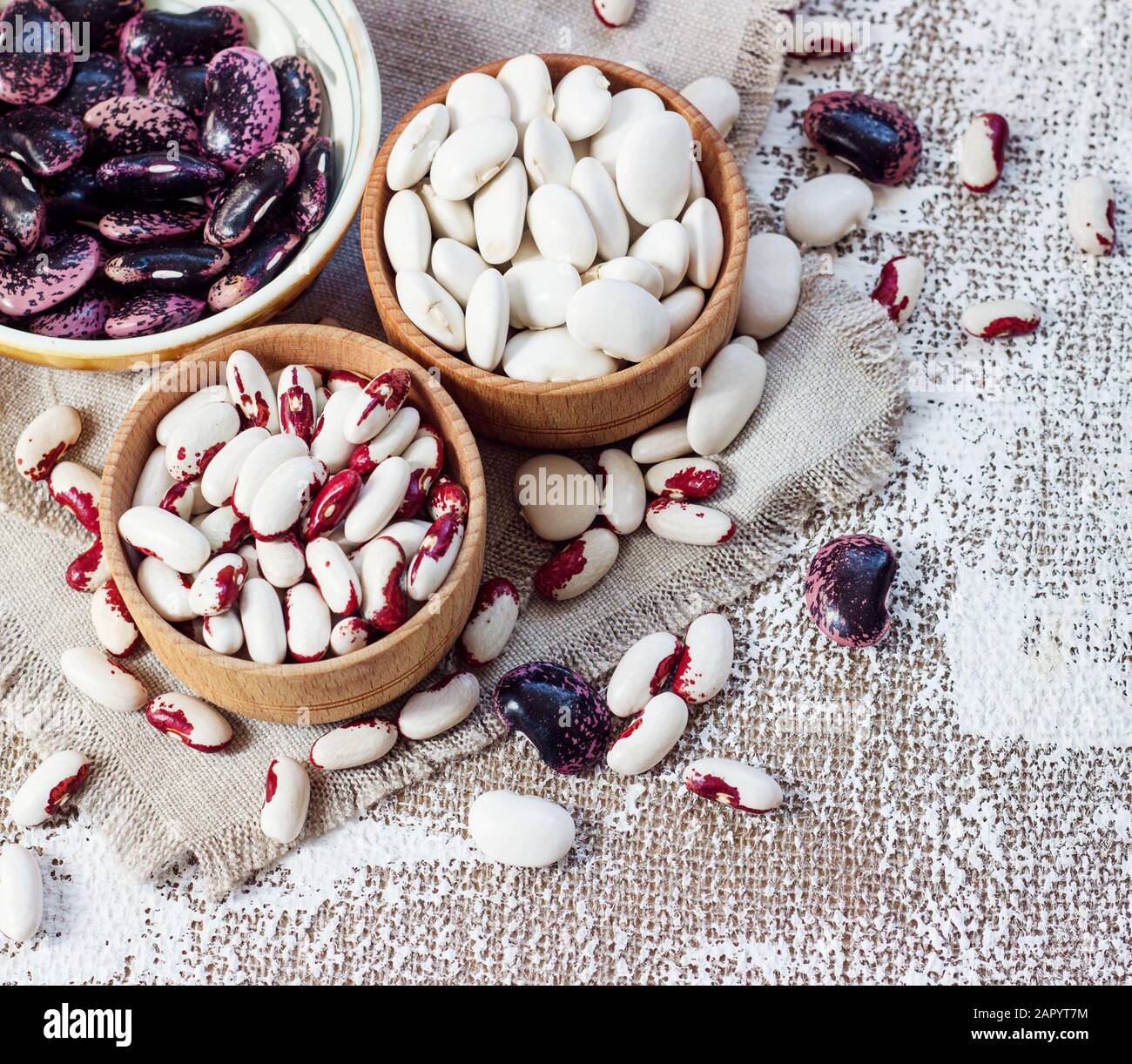 colored beans in wooden cups on a light background Stock Photo - Alamy
