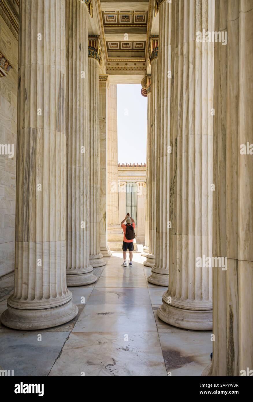Tourist photographing the portico of the The Academy of Athens, part of ...