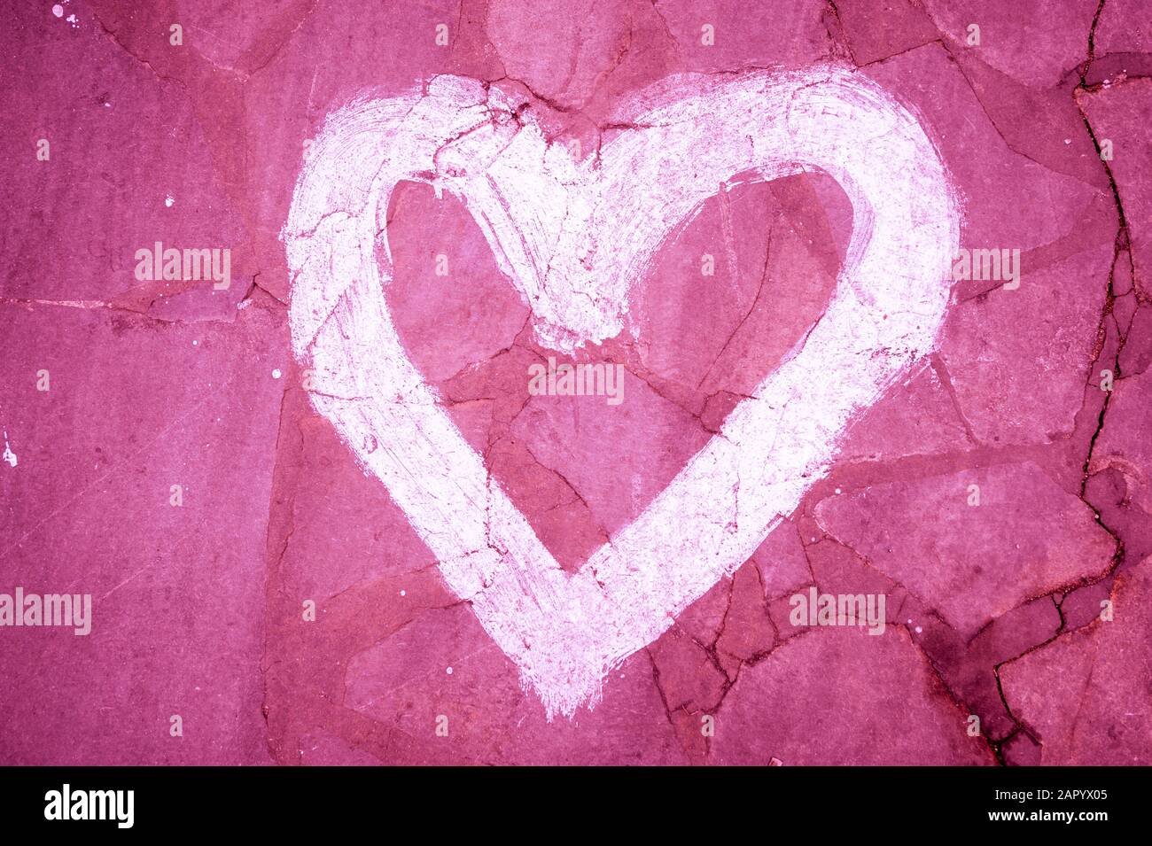 Simple pink painted heart on textured stone slab with cracks Stock ...