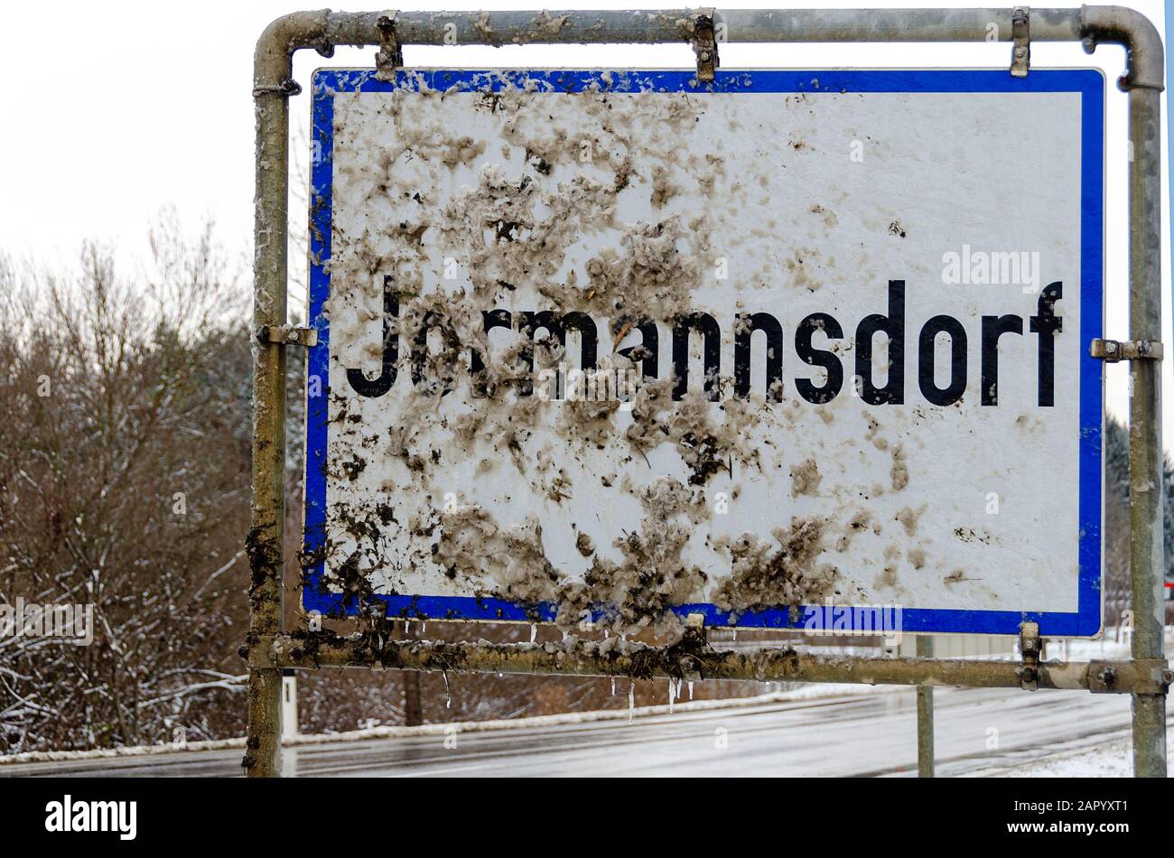 Dirty slush on a place name sign Stock Photo - Alamy