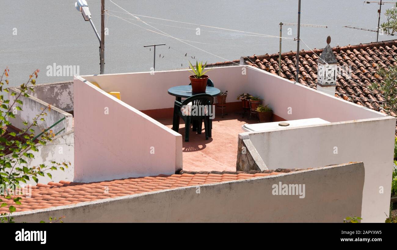 Roof terrace with table and chairs Stock Photo - Alamy