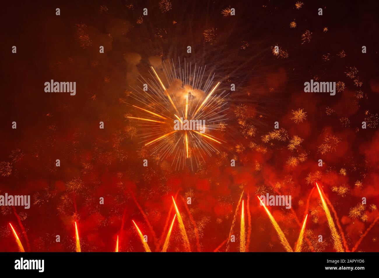 Beautiful orange fireworks display in the urban for celebration on dark ...