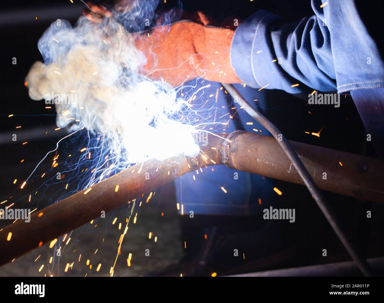 Electric welding works on the pipeline in a dark room Stock Photo - Alamy