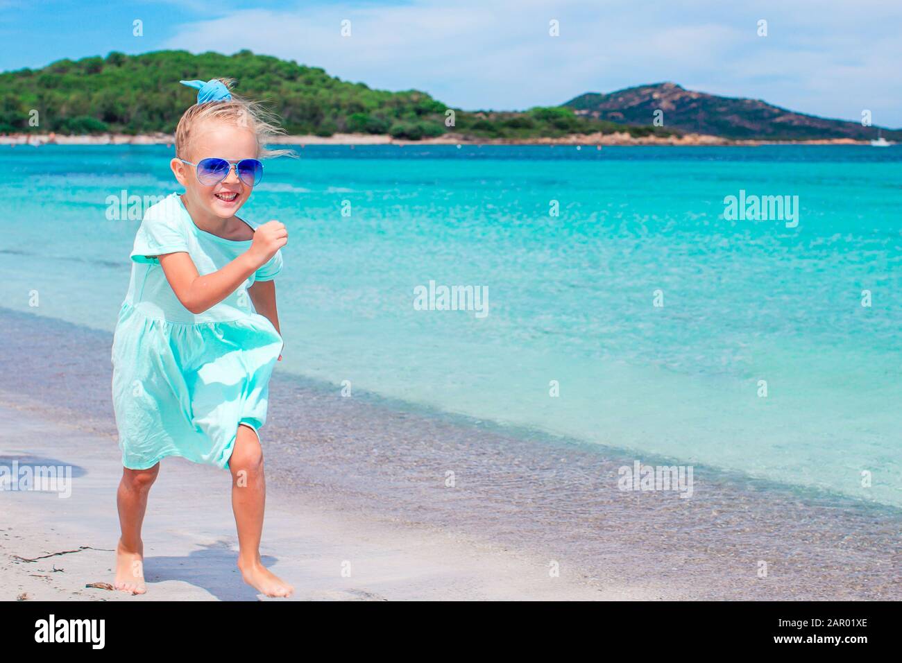 Adorable little girl on the beach. Happy girl enjoy summer vacation ...