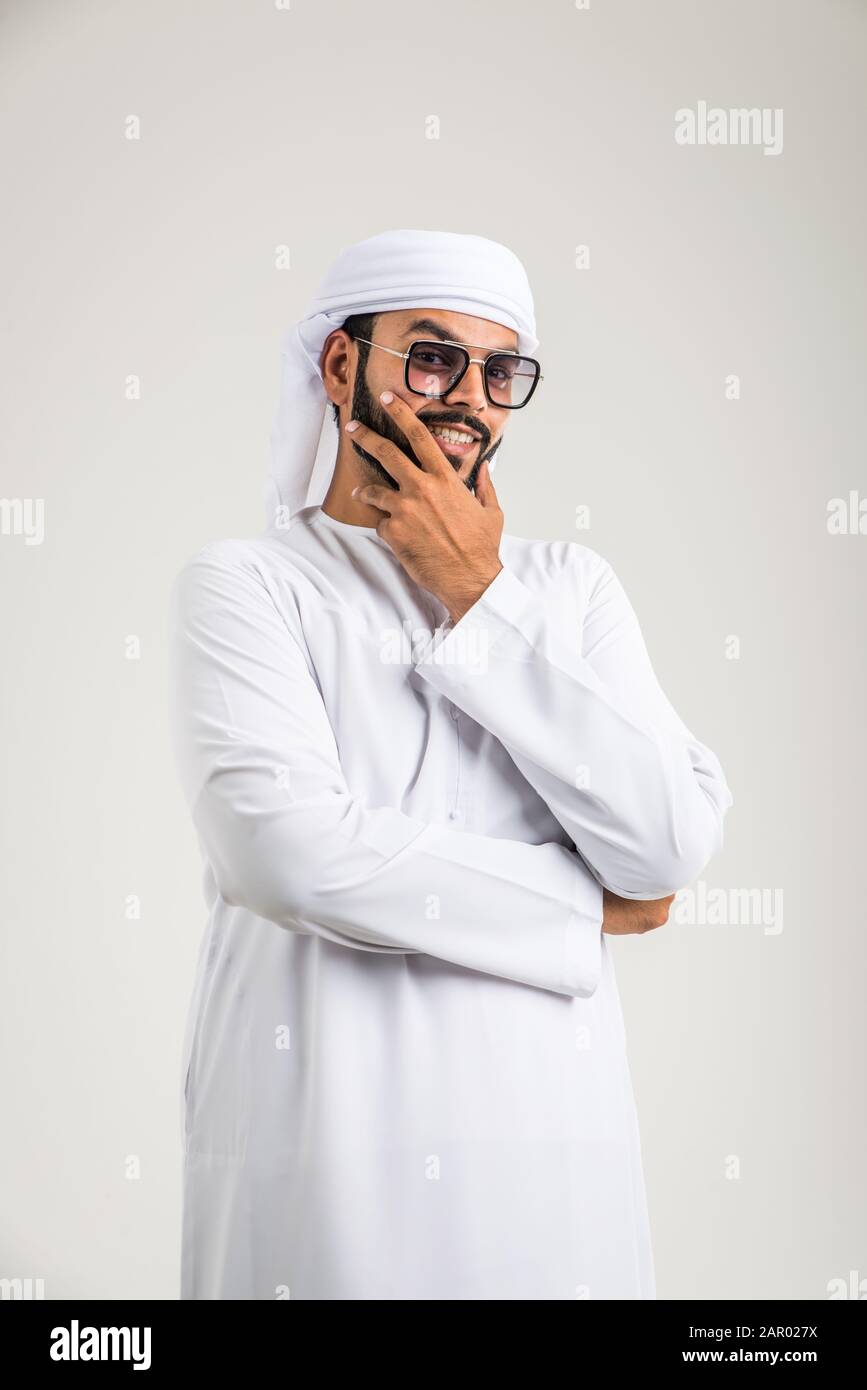 Middle eastern man with traditional emirates dresses posing in a ...