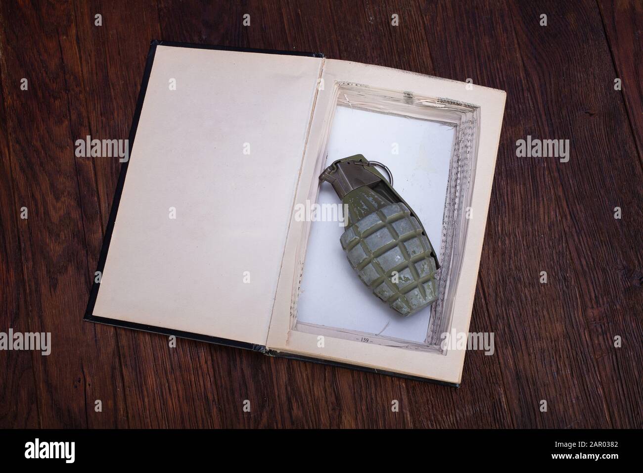 Gun hidden in book hi-res stock photography and images - Alamy