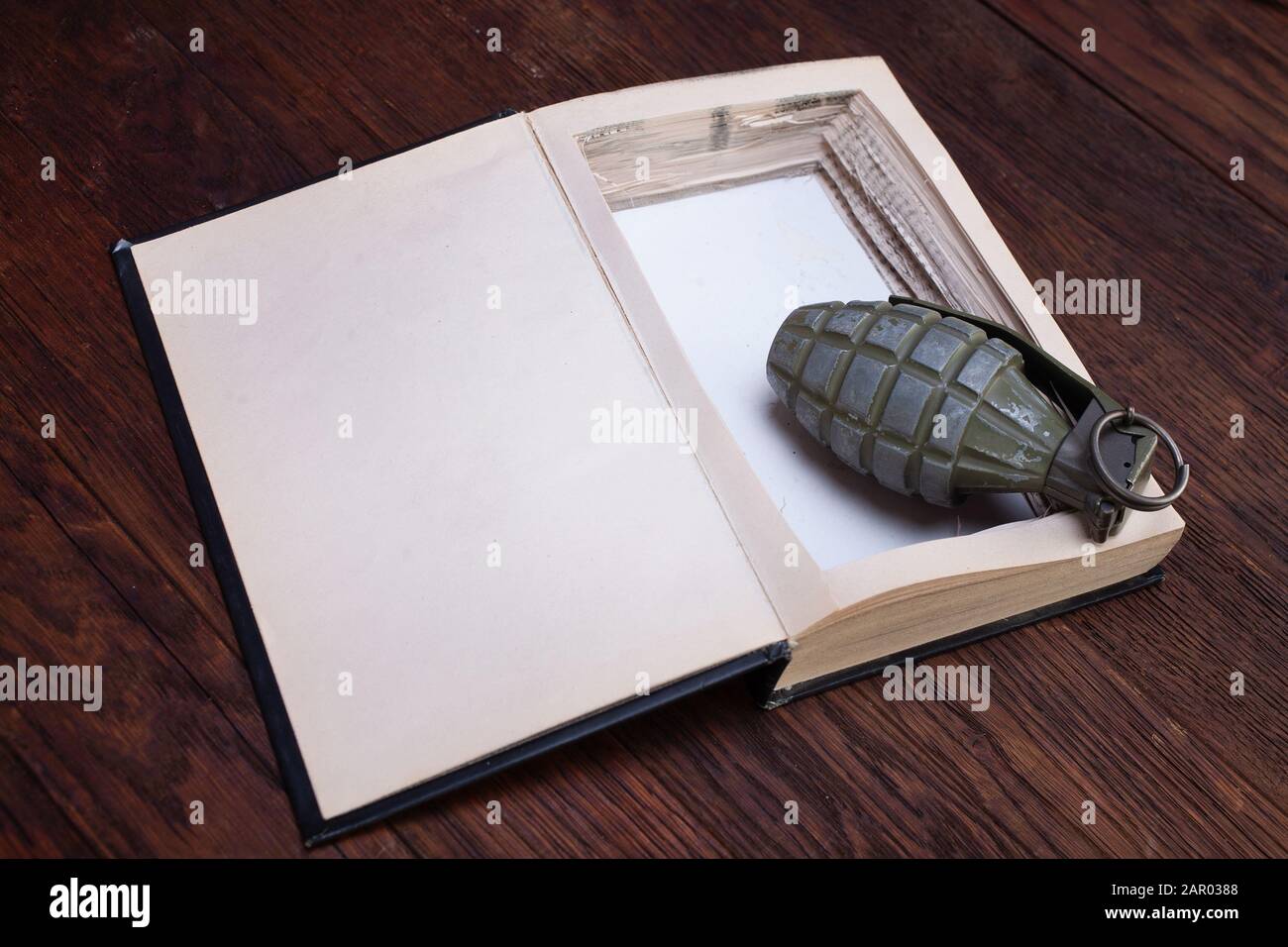 Gun hidden in book hi-res stock photography and images - Alamy