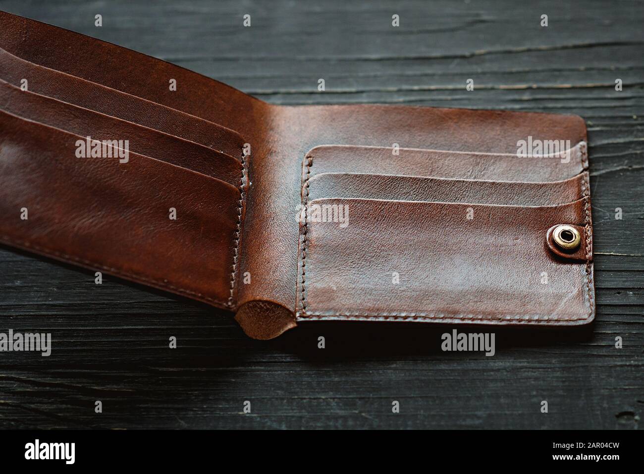 leather handmade craft vintage brown empty wallet on black wooden ...