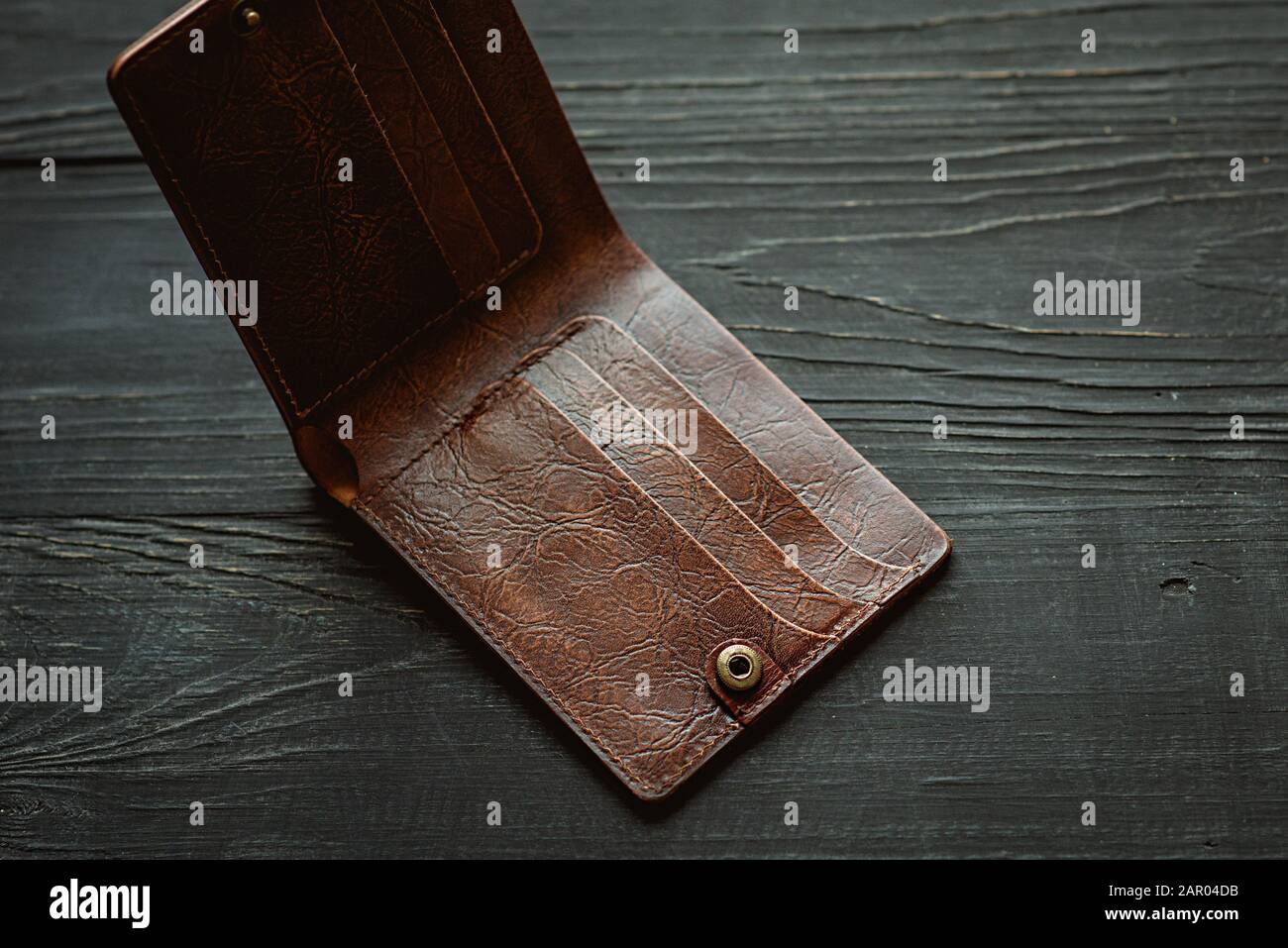 leather handmade craft vintage brown empty wallet on black wooden ...