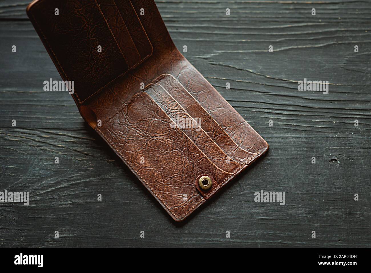 leather handmade craft vintage brown empty wallet on black wooden ...