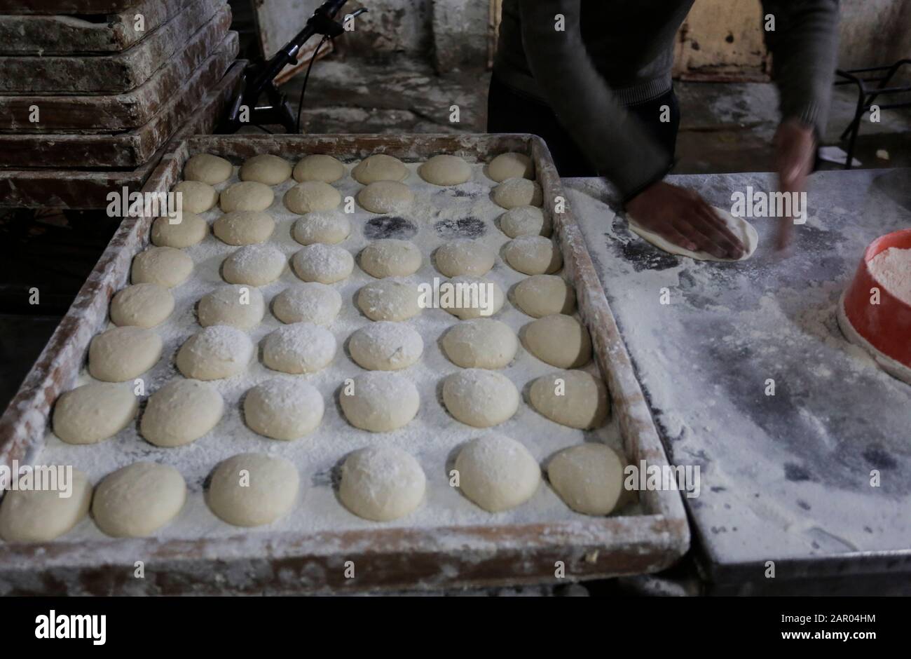 A Palestinian seller prepares traditional bread known as "Saj" in Gaza ...