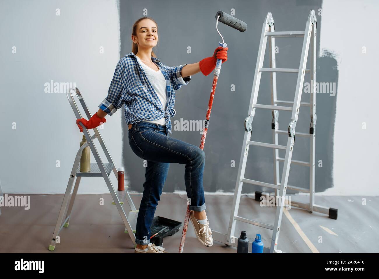 Female house painter sitting on a ladder Stock Photo - Alamy