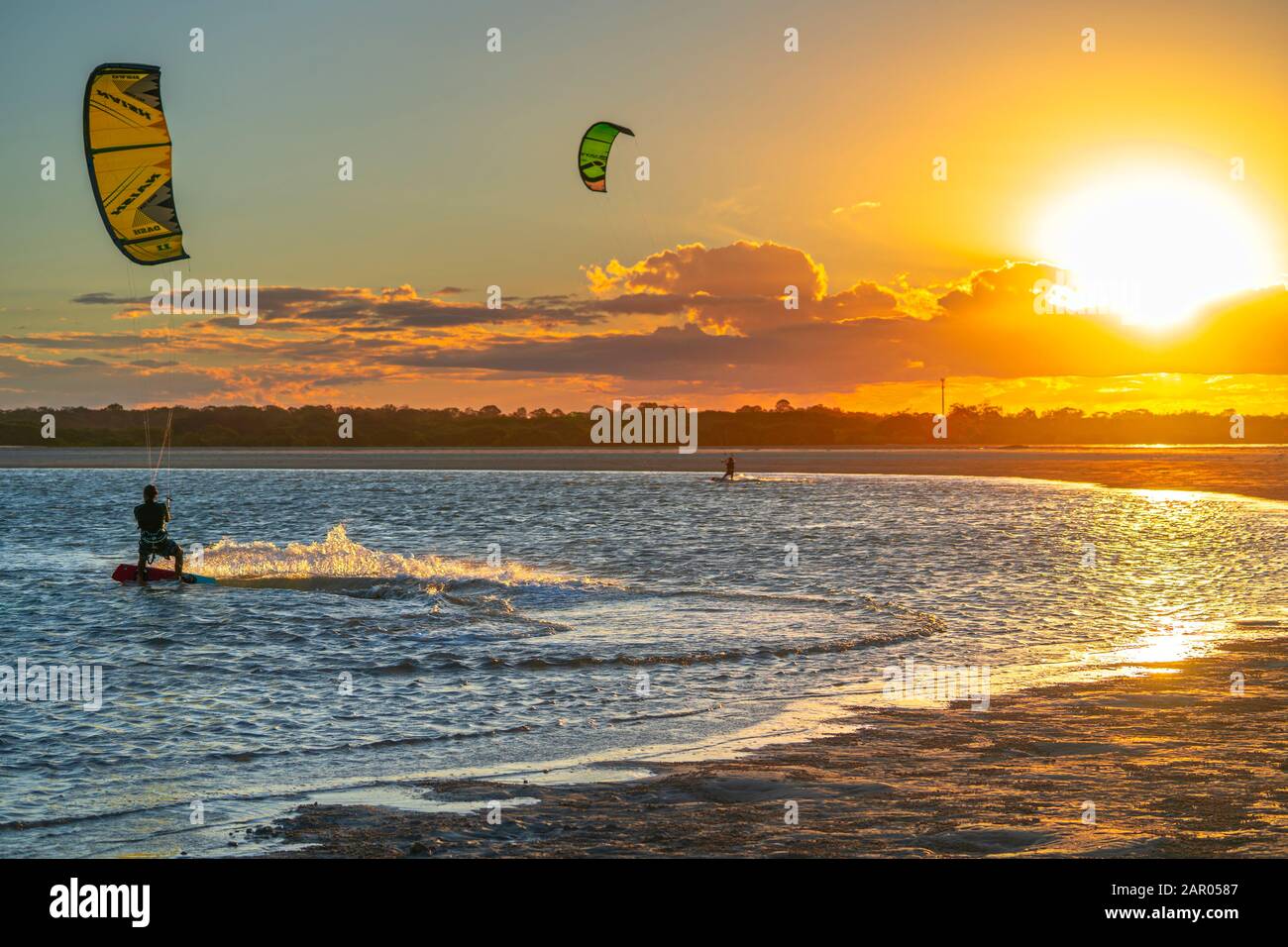 Kite Surfers at sunset at Elliott Heads, Queensland Stock Photo - Alamy
