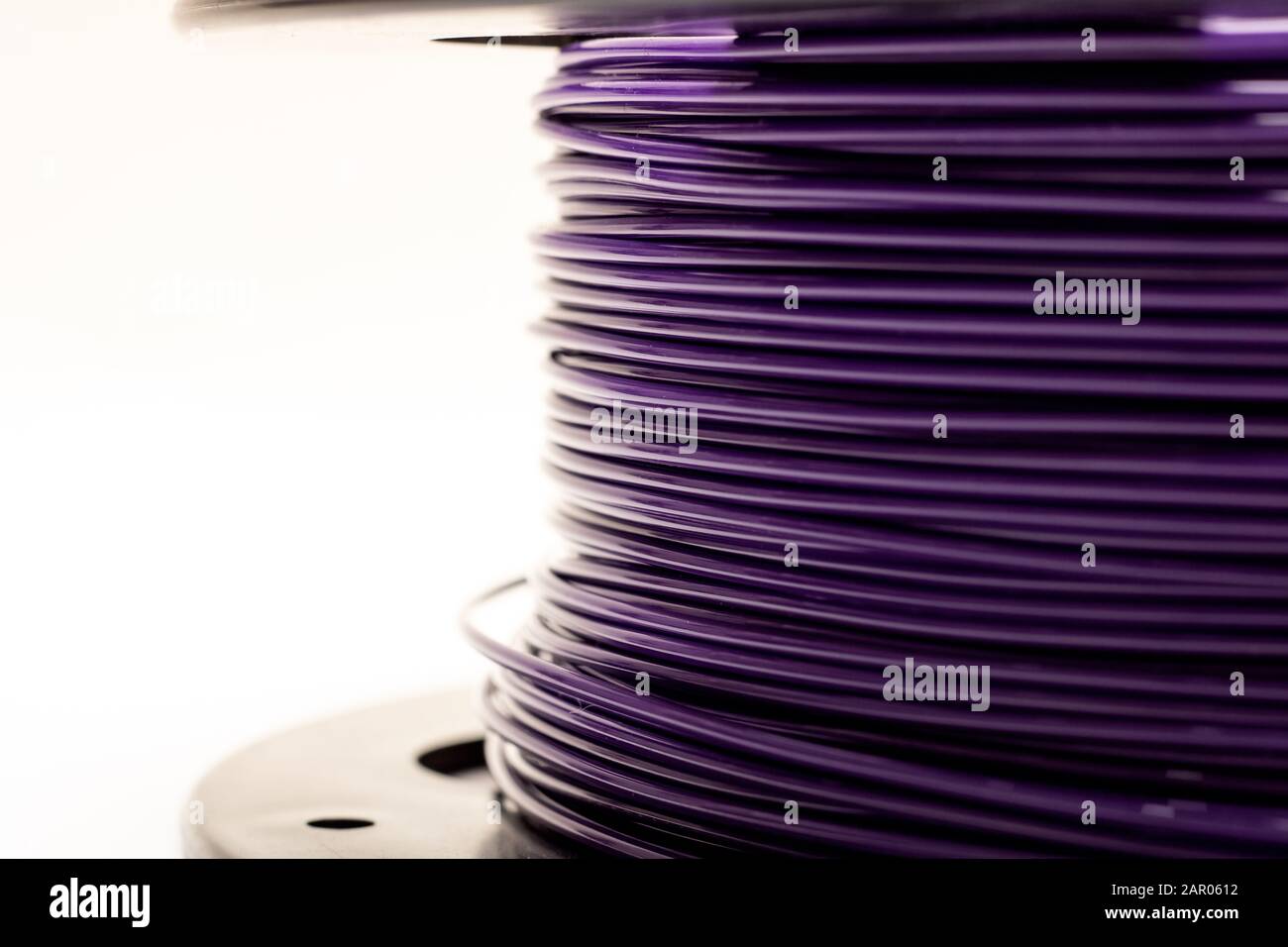 Coil with purple wires on a white background Stock Photo - Alamy