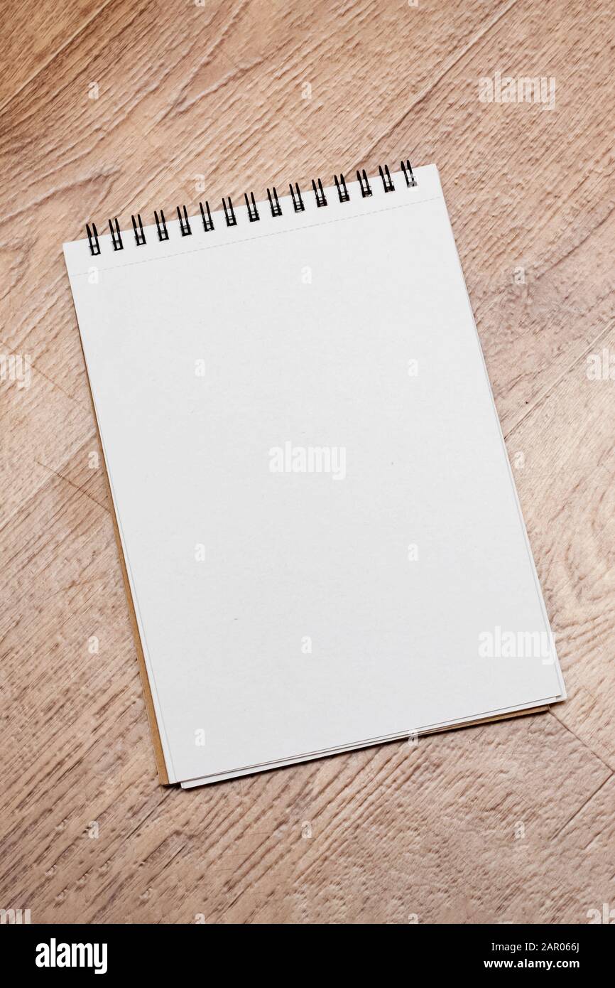 Notebook on a wooden table close up Stock Photo - Alamy