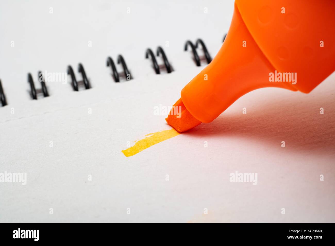 Orange marker and line on notepad paper Stock Photo - Alamy
