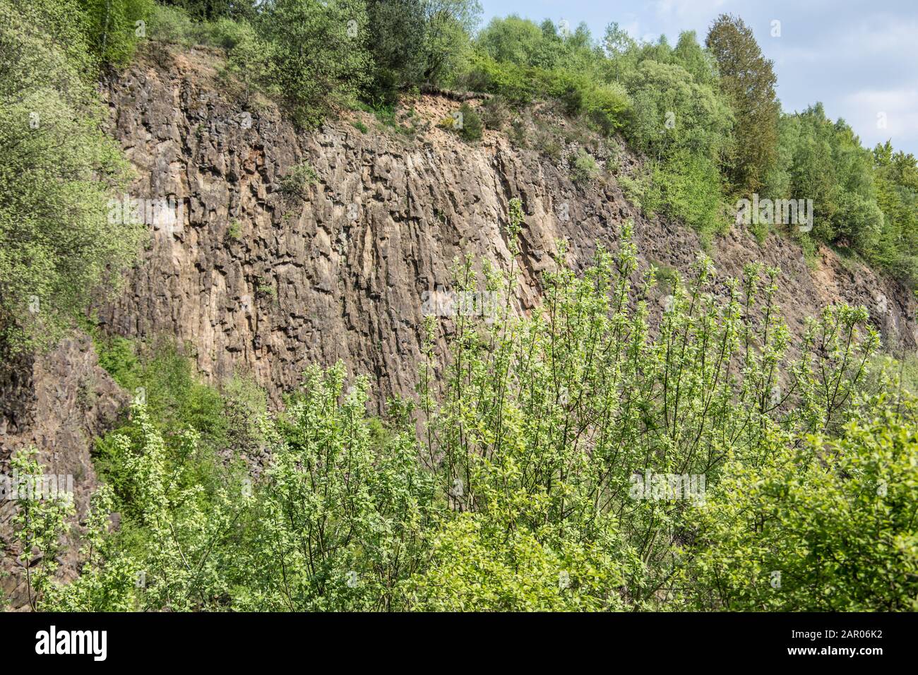 Mountain slope made of basalt rock on the lake Stock Photo - Alamy