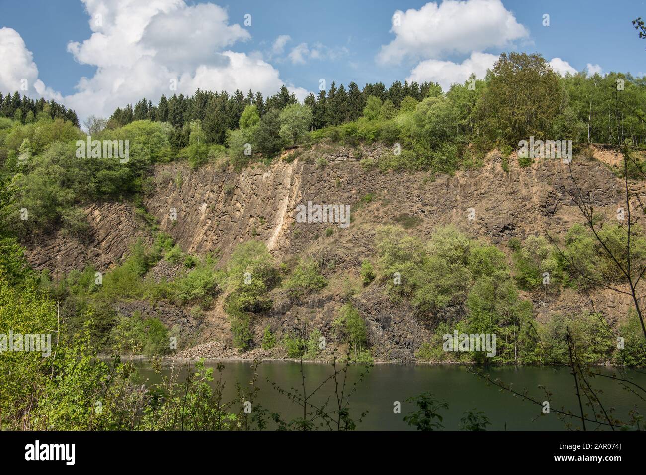Mountain slope made of basalt rock on the lake Stock Photo - Alamy