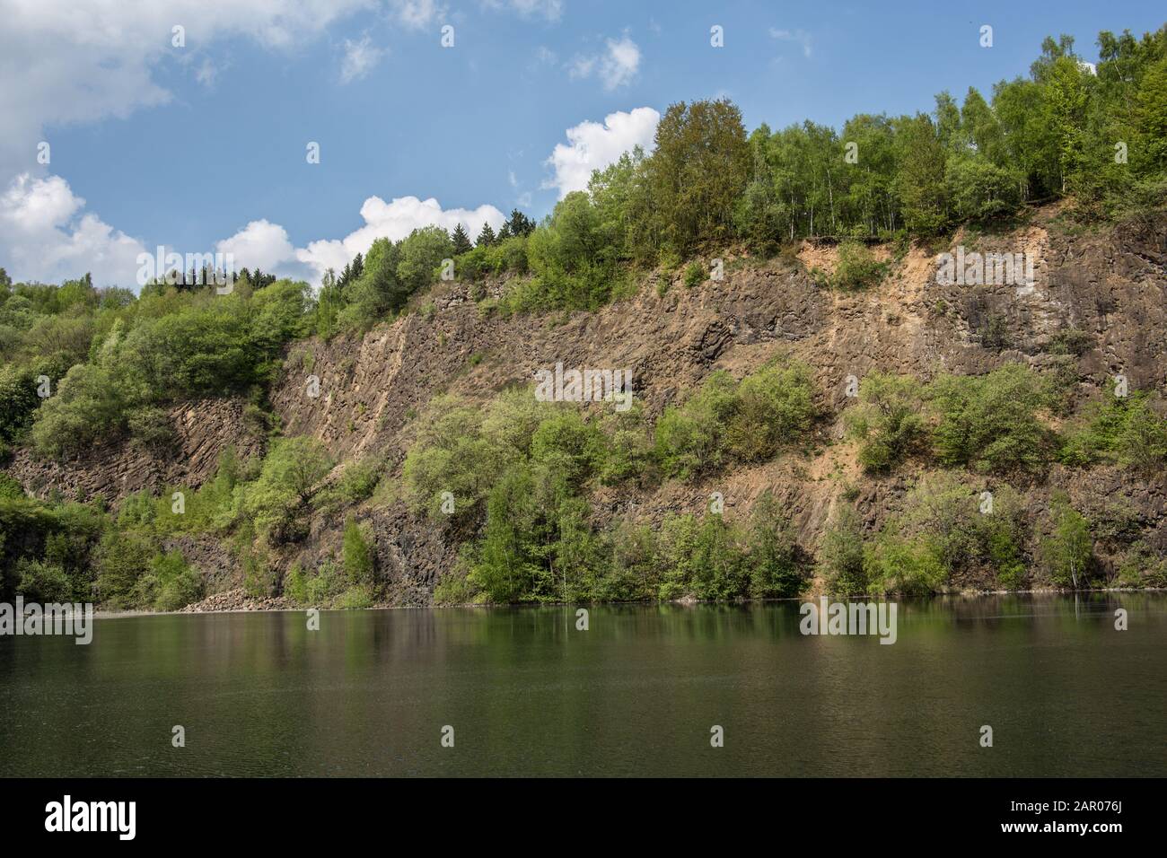 Mountain slope made of basalt rock on the lake Stock Photo - Alamy
