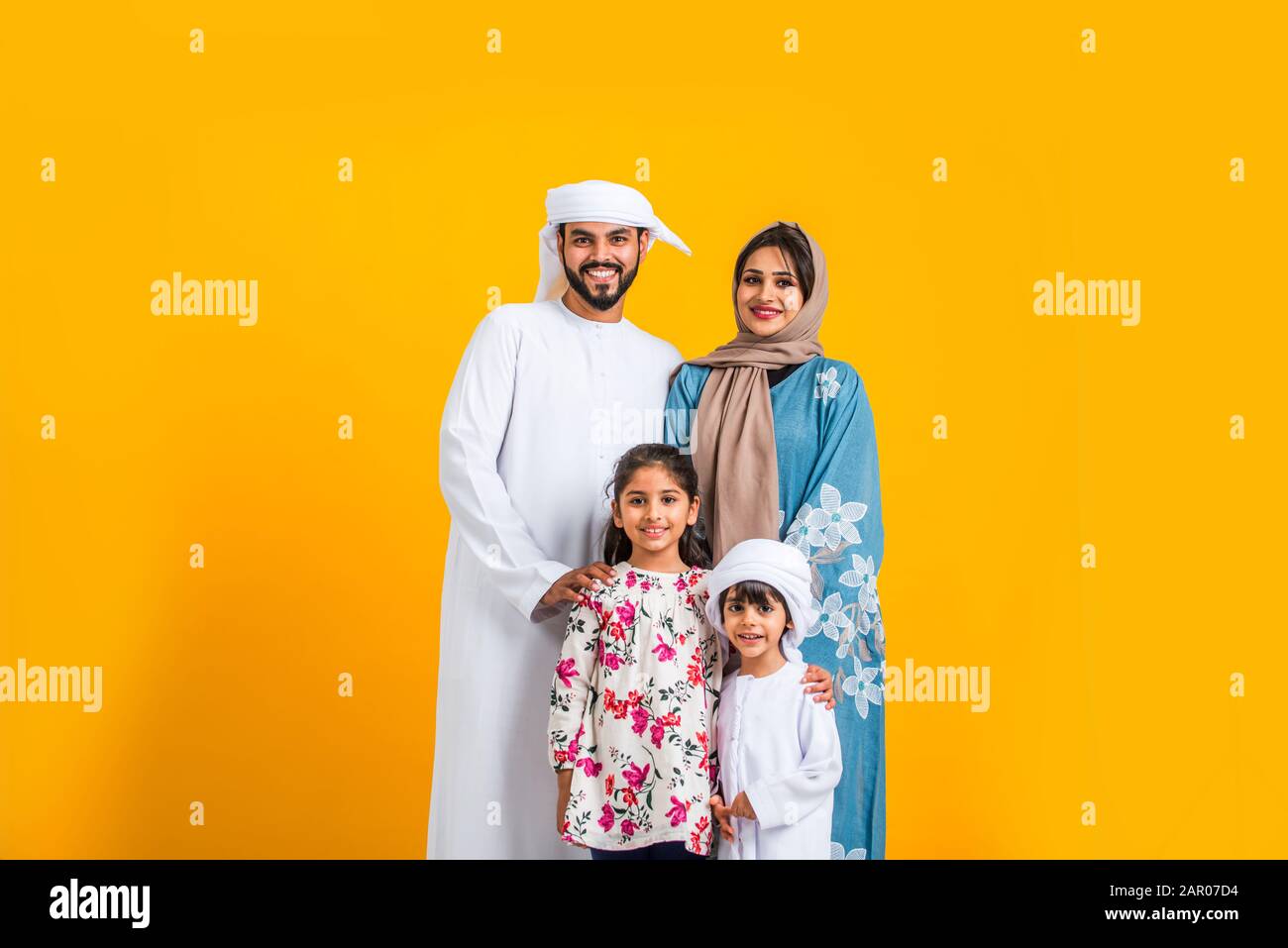 Middle eastern family with traditional emirates dresses posing in a ...