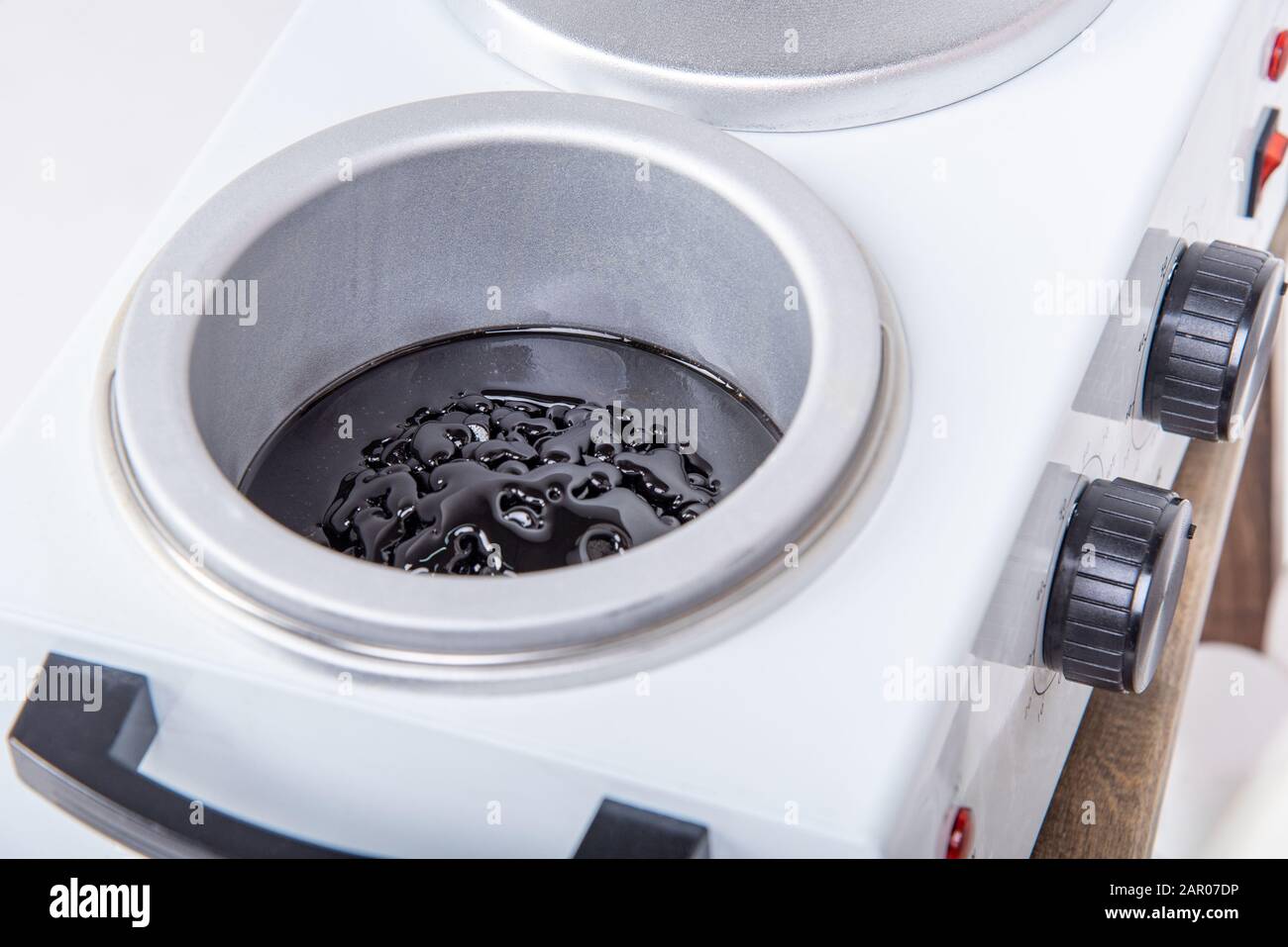 Preparation of black wax for shugaring. Close-up wax for depilation is ...