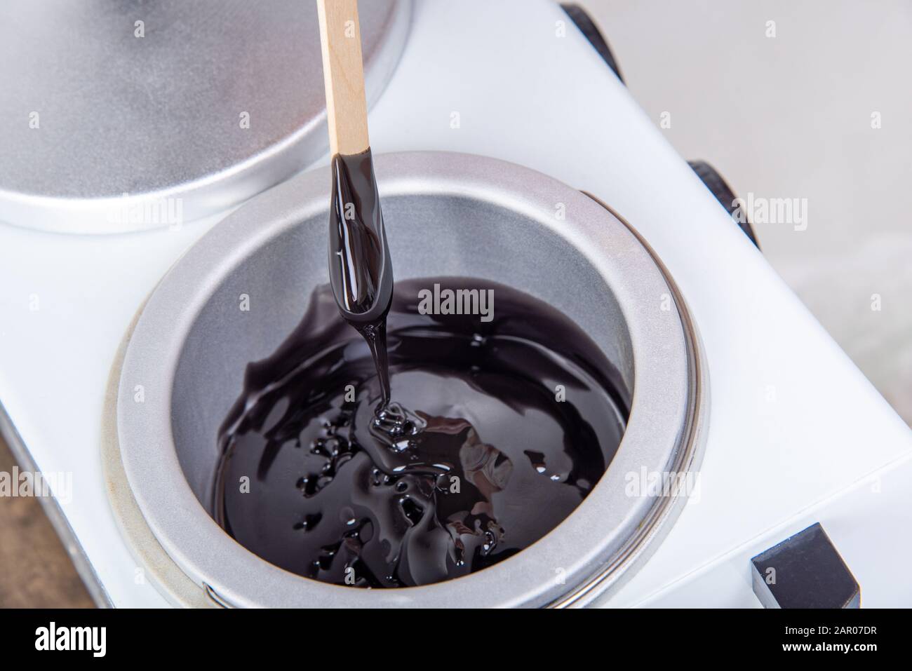 Preparation of black wax for shugaring. Close-up wax for depilation is ...