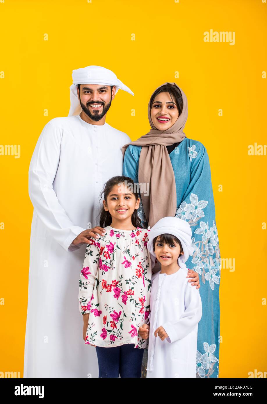 Middle eastern family with traditional emirates dresses posing in a ...