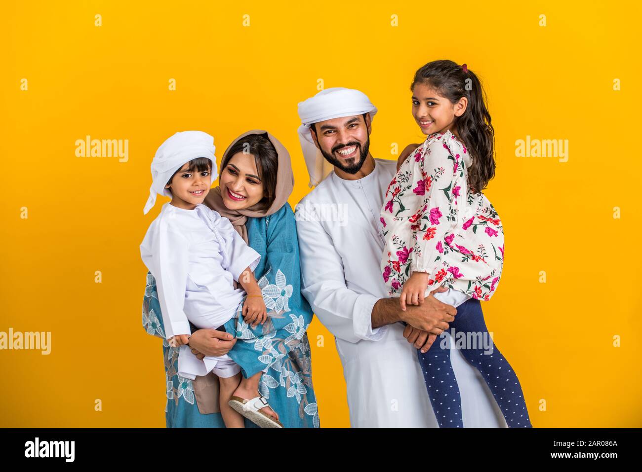 Middle eastern family with traditional emirates dresses posing in a ...