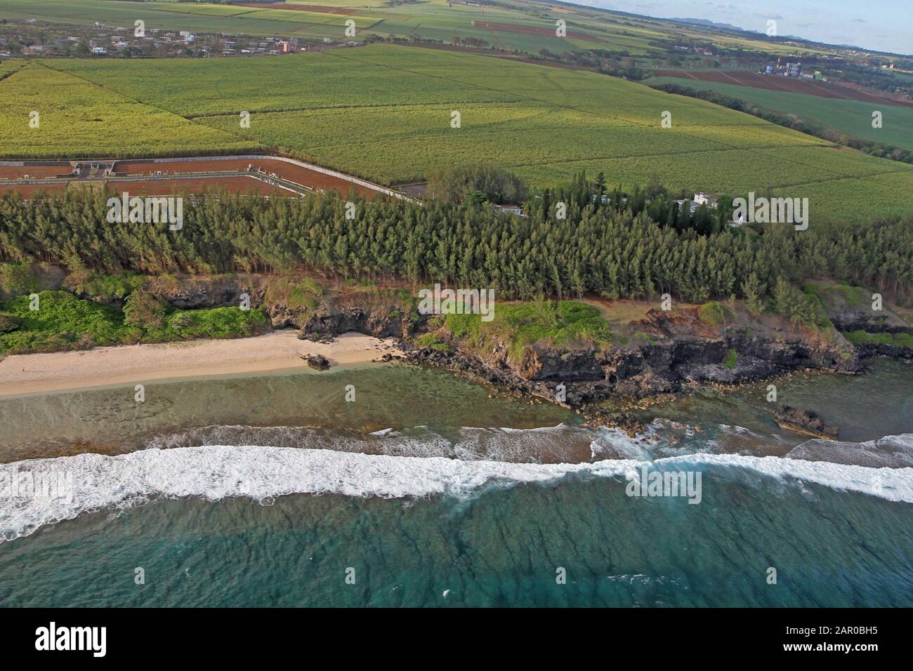 Rocky beach with woods, agricultural fields and water reservoir ...