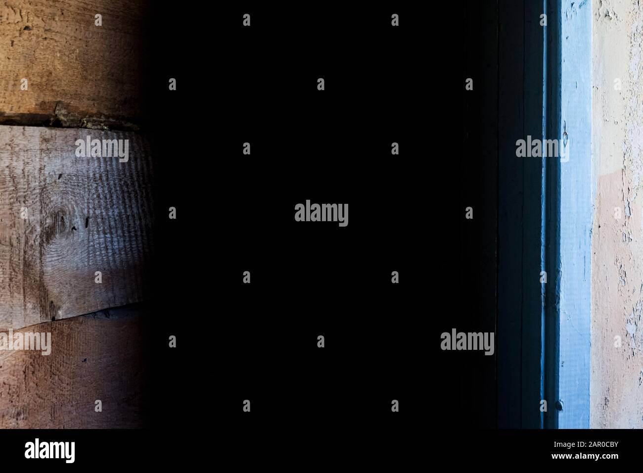 Old open door and darkness inside close up Stock Photo - Alamy