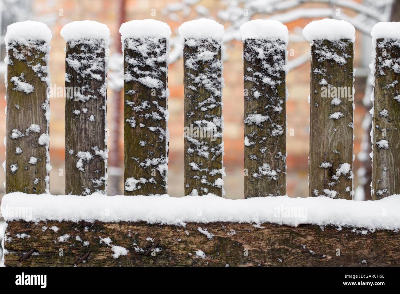 Wooden rural fence covered with snow Stock Photo - Alamy