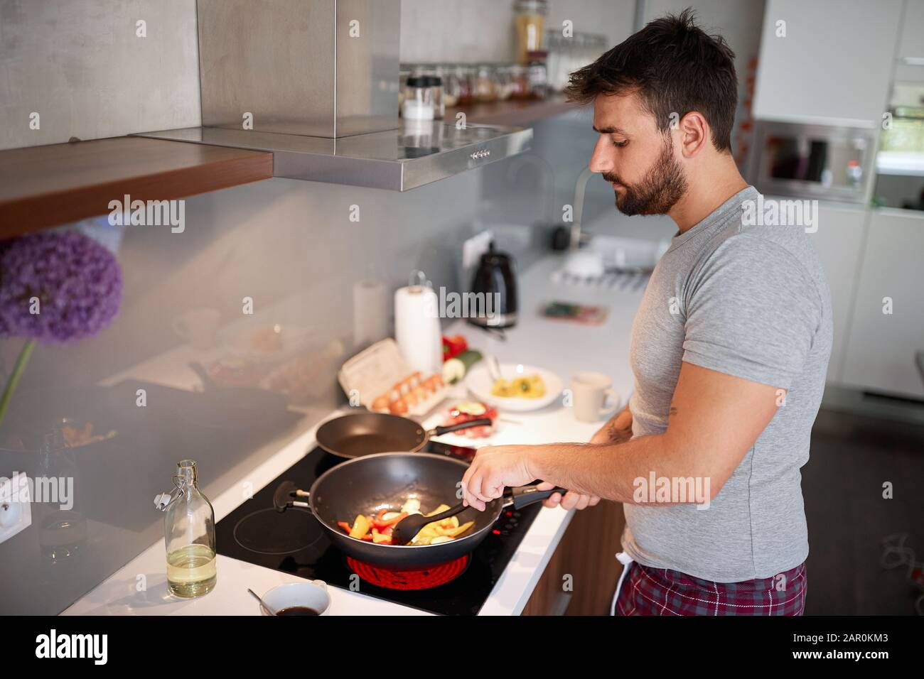 Sleepy man prepare breakfast in pajamas Stock Photo - Alamy