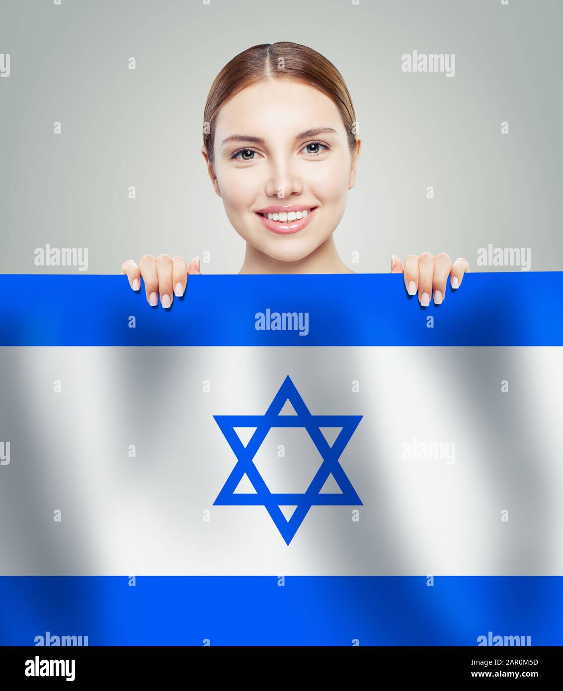 Beautiful happy young woman showing the Israel flag background. Live ...