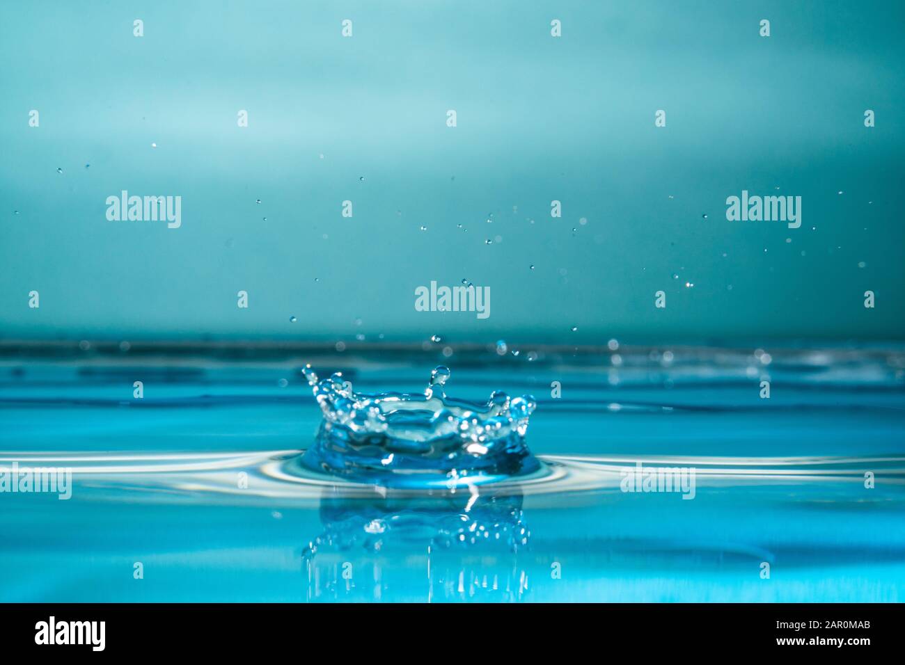 Drop of water falling into a glass, hitting water surface.Selected ...