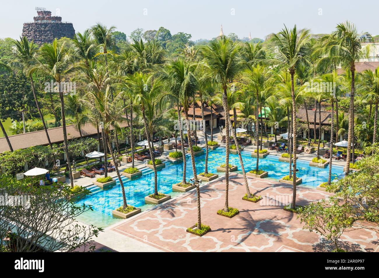Outdoor pool surrounded by palm trees at Chatrium Hotel, Royal Lake ...