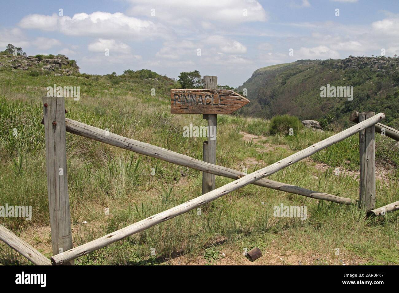 Entrance gate and sign pointing to The Pinnacle Rock in Driekop Gorge ...