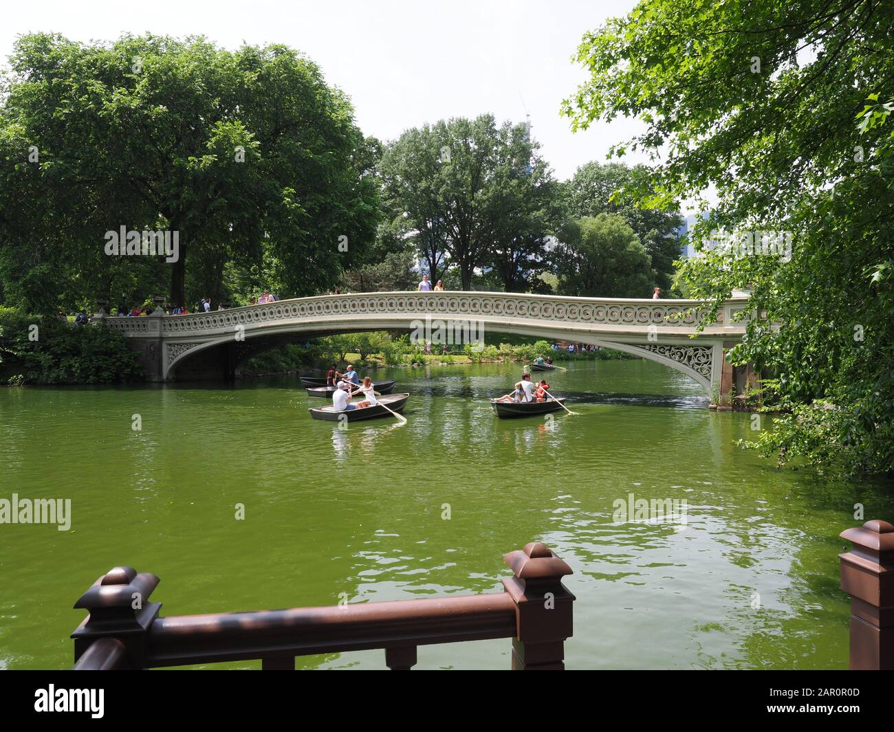 New York, USA - June 2, 2019: People rowing under the Bow Bridge in ...