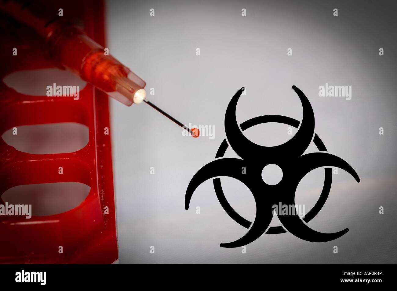 Syringe with blood droplet and biohazard sign Stock Photo - Alamy