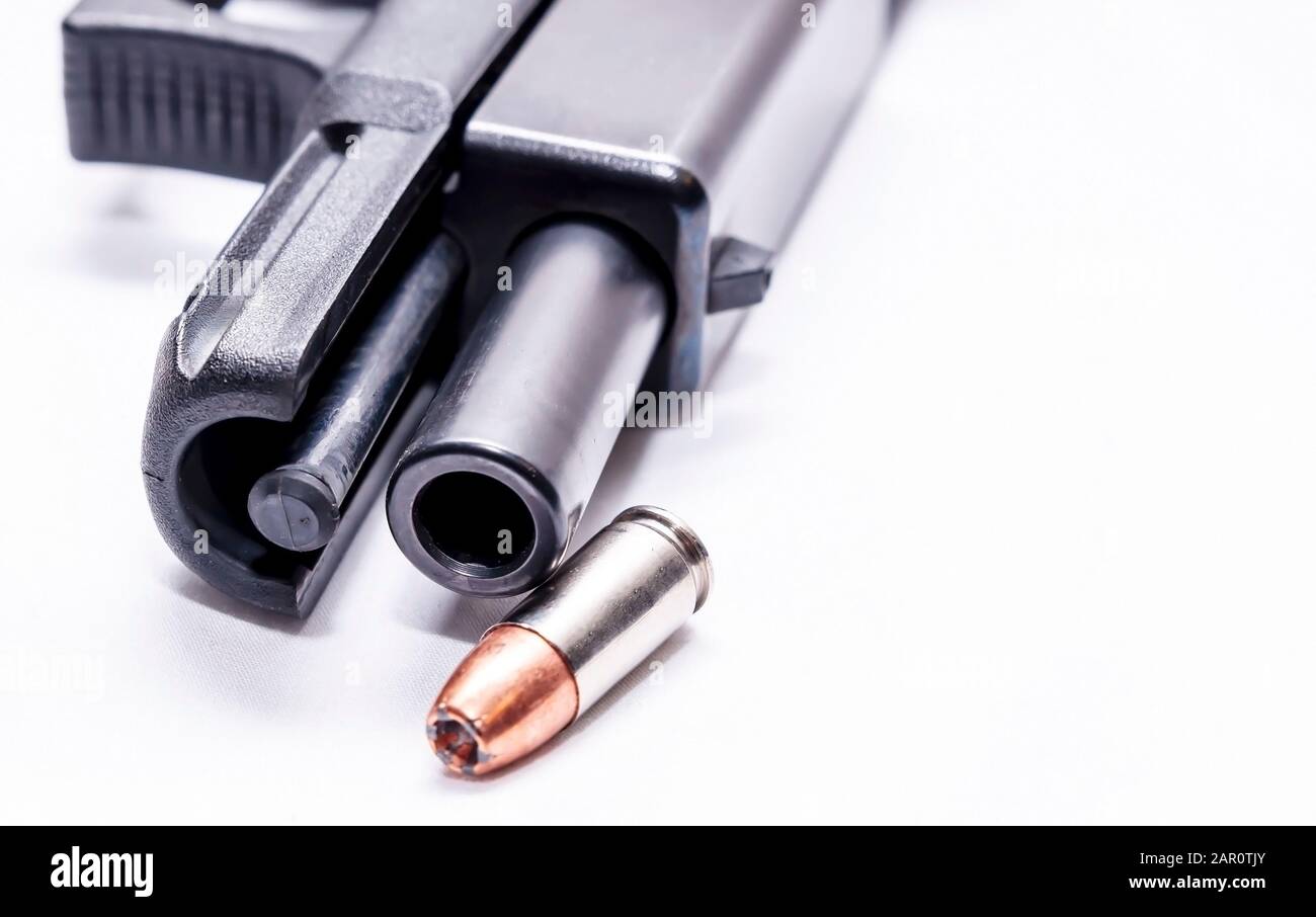 A black 9mm semi automatic with it's slide opened showing the barrel ...