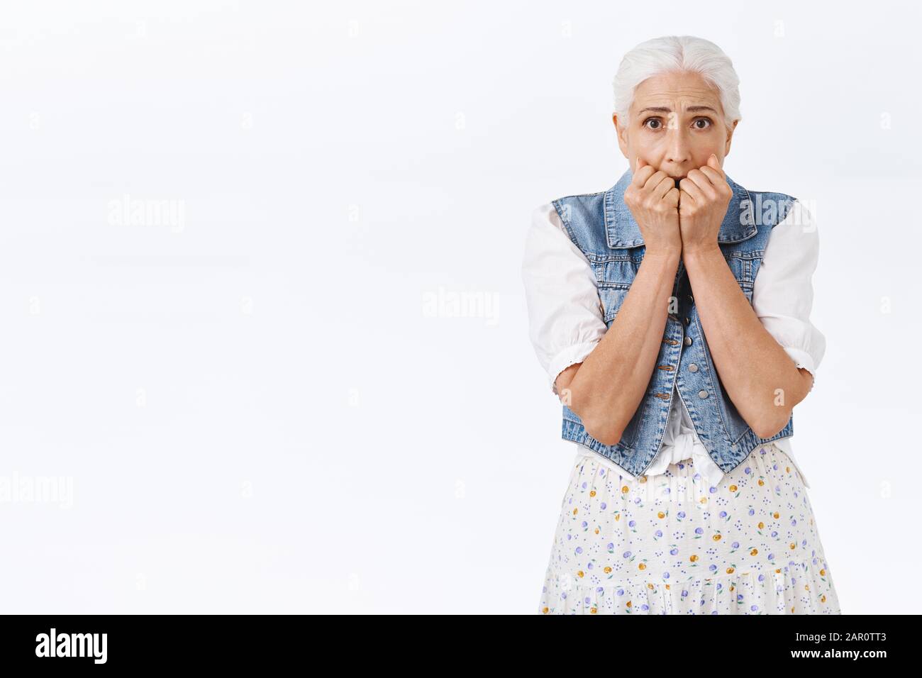 Alarmed, frightened innocent and insecure, scared senior woman with ...