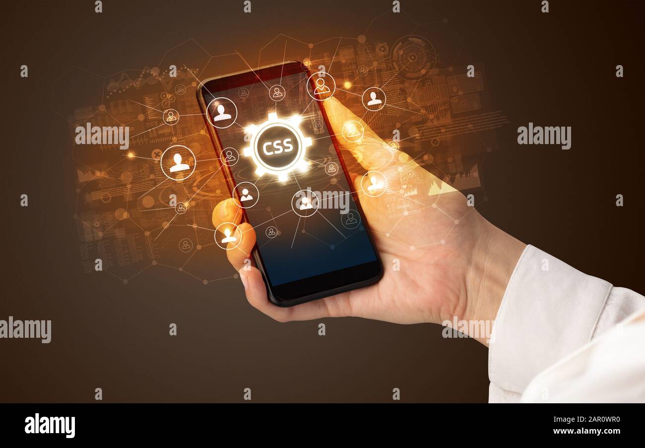 Female hand holding smartphone with CSS abbreviation, modern technology ...