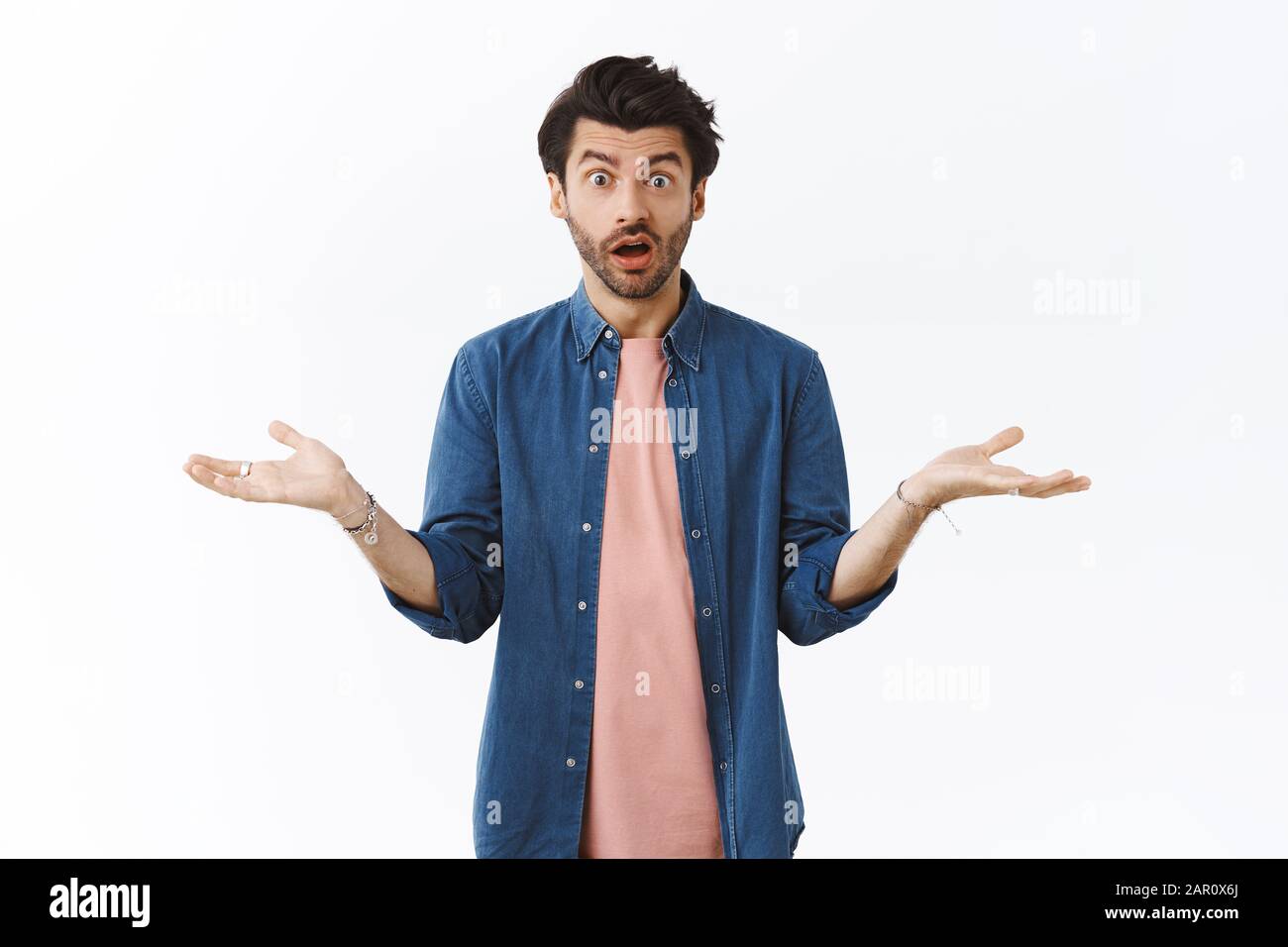 Surprised and confused young man cant understand what happened ...