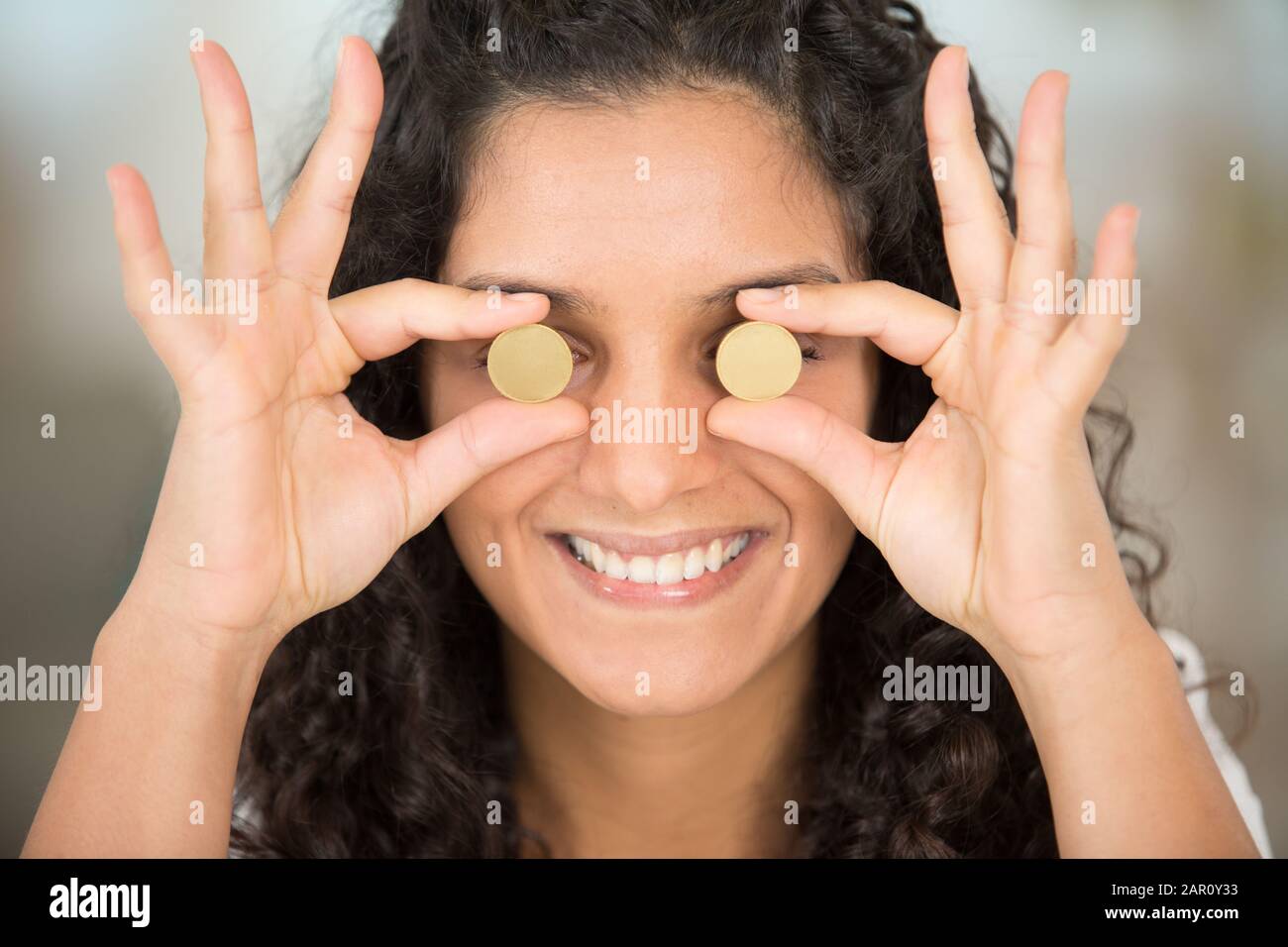 coins on the eyes as symbol of rich Stock Photo - Alamy