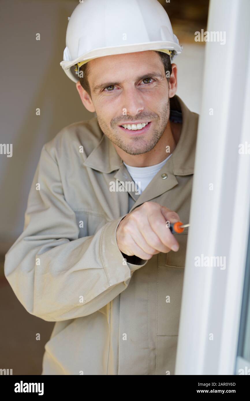 happy contractor installing a door Stock Photo - Alamy