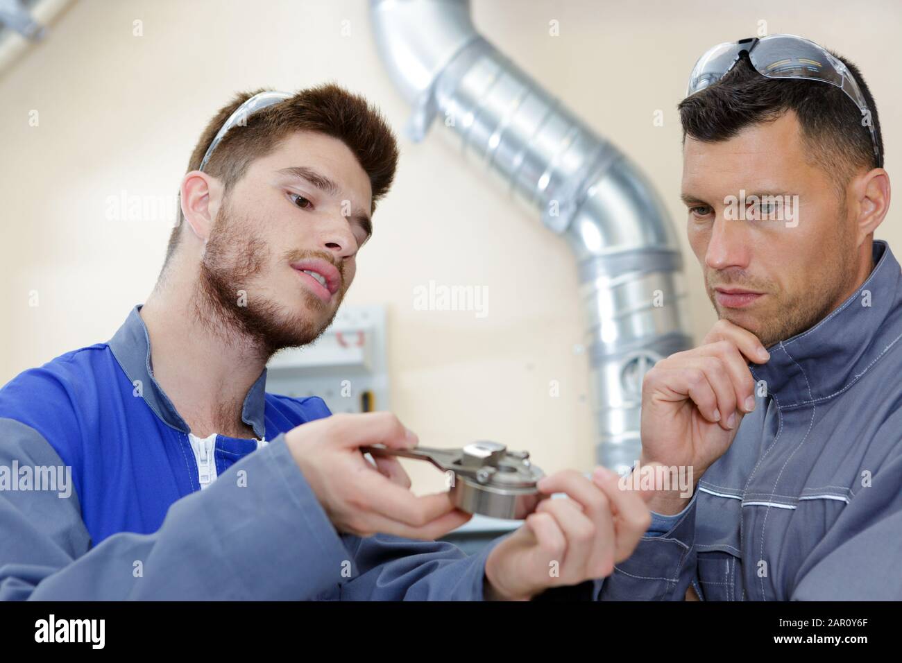 portrait of two mechanics working together Stock Photo - Alamy