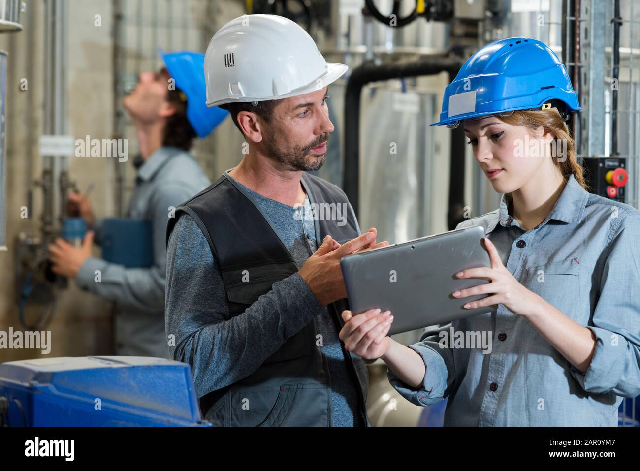 using digital tablet in factory Stock Photo - Alamy