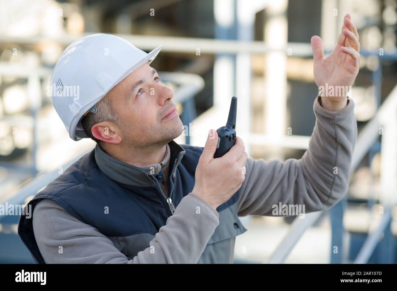 male worker using walkie-talkie outdoors Stock Photo - Alamy