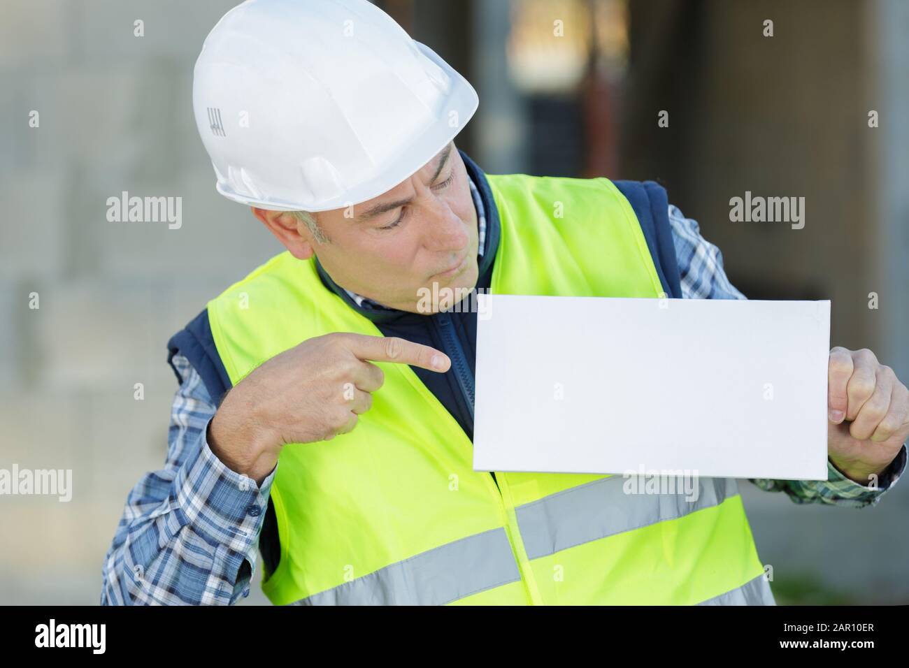 builder - construction worker showing sign Stock Photo - Alamy