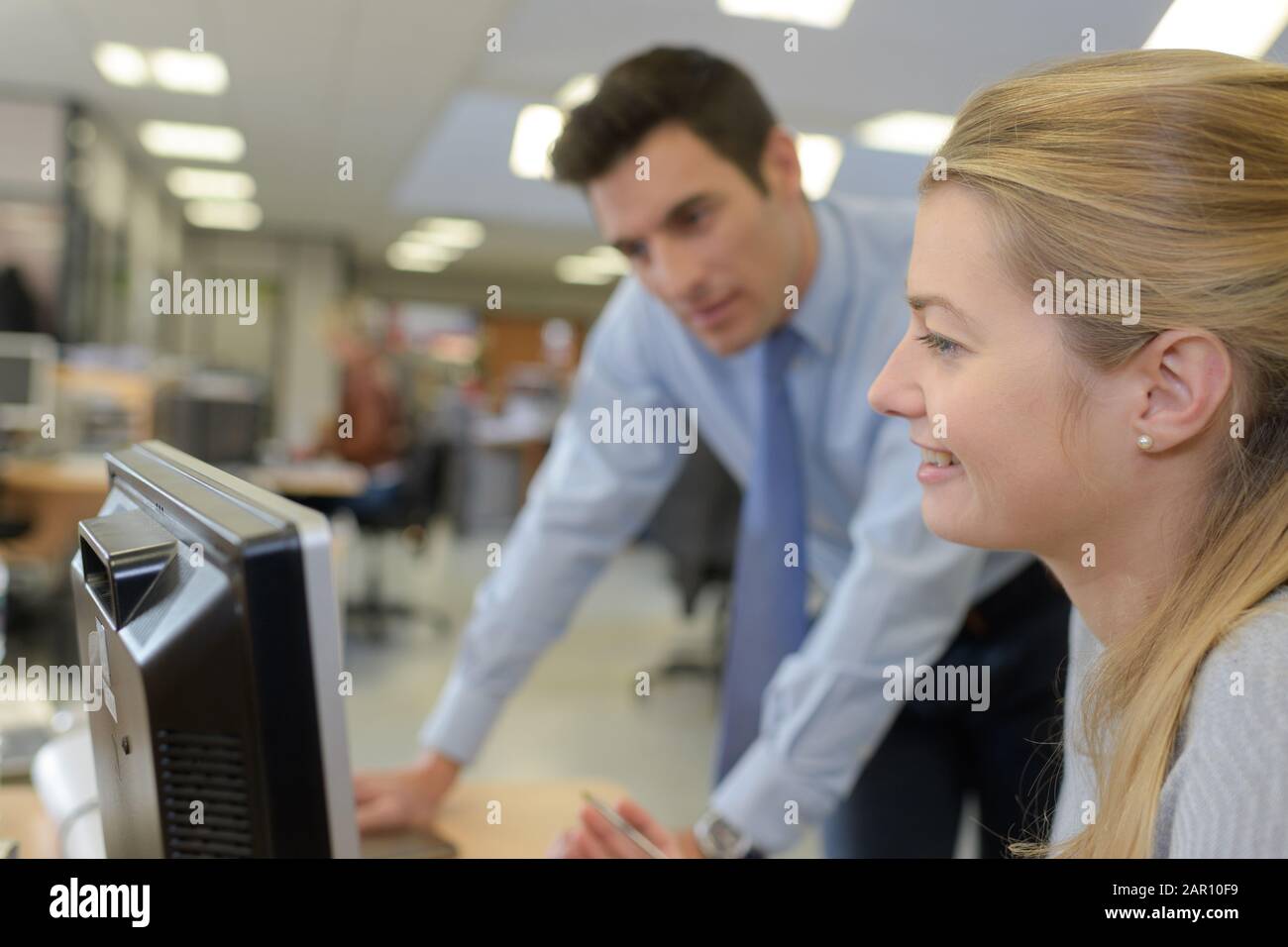secretary smiling in front of the computer Stock Photo - Alamy