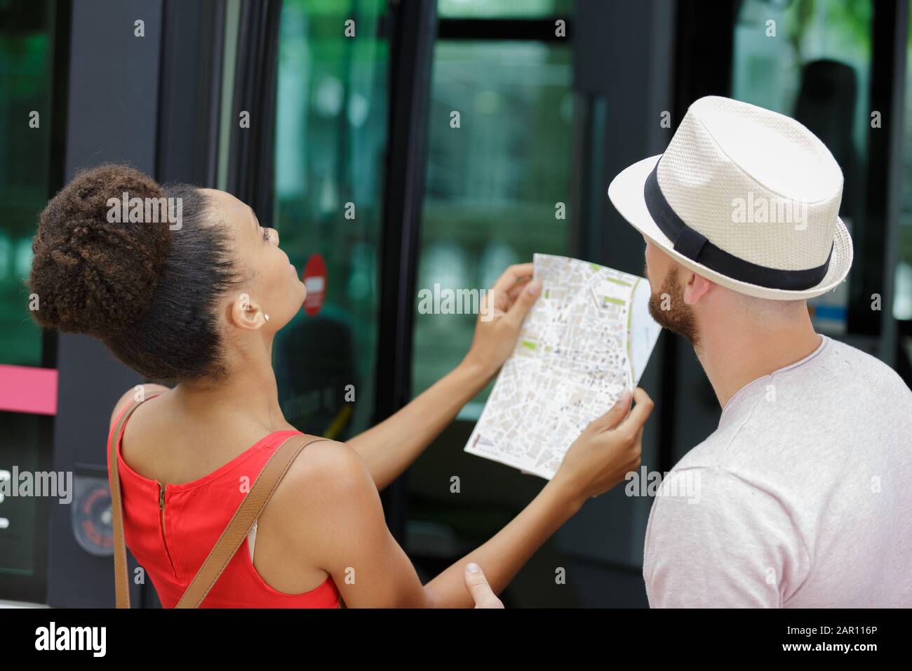 happy tourist checking a map Stock Photo - Alamy